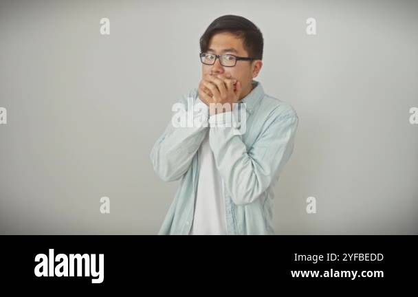 Shocked young chinese man, hands covering mouth, realizing a surprising ...
