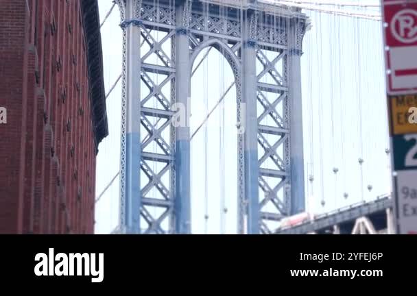 New York City Manhattan Bridge in Dumbo, Brooklyn. Red brick building on Washington street near ...