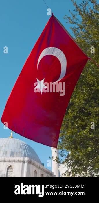 Turkish flag on background of mosque. Action. Turkish flag is flying in ...