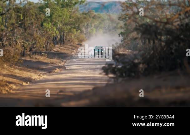 4wd 4x4 suv drives on a gravel road leaving dust behind. Ram TRX is the ...