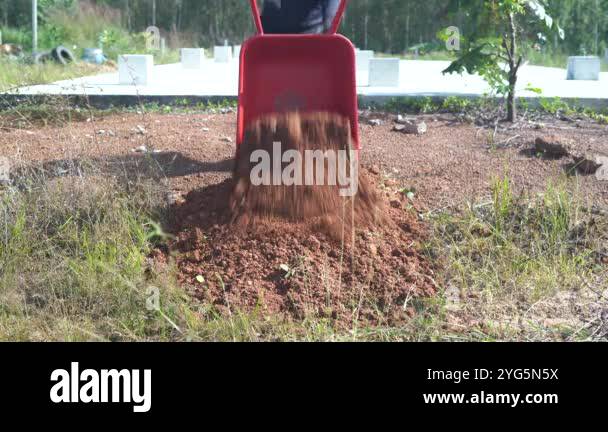 Construction site workers are digging up soil, loading it into a ...