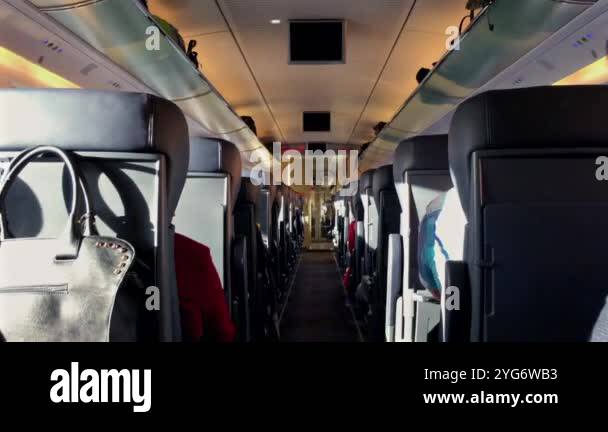 Interior of commercial airplane cabin with passengers seated, ready for ...