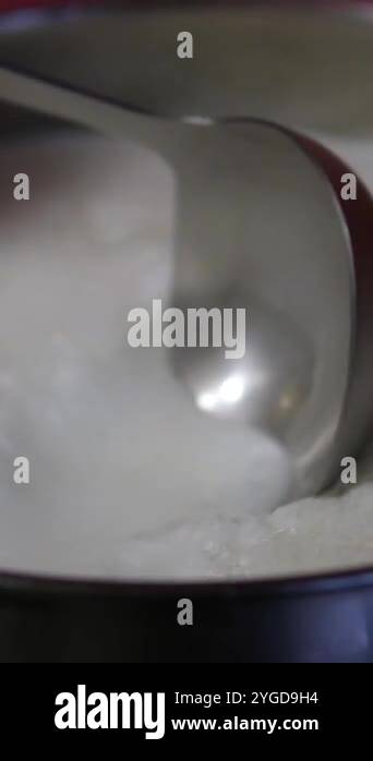 Milk boils and steams hot. Boiling milk in a stainless steel vessel ...