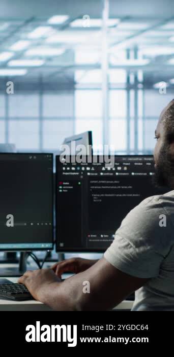 Sick IT professional in server hub sneezing while shielding data from potential threats using PC ...