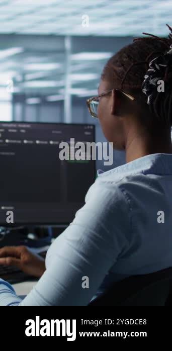 Isolated screen tablet in front of IT support workers coding on ...