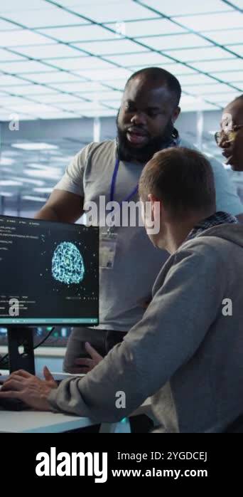 Technician doing brainstorming with colleagues to fix error in code affecting server room AI ...
