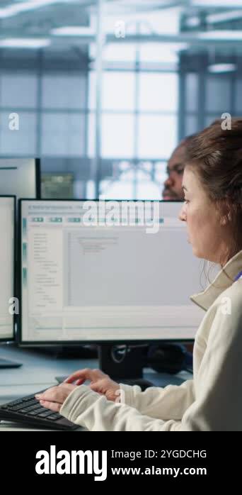 Manager supervising multiethnic team working in data center, making ...