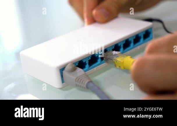 Connecting an ethernet cable to a hub Stock Video Footage - Alamy