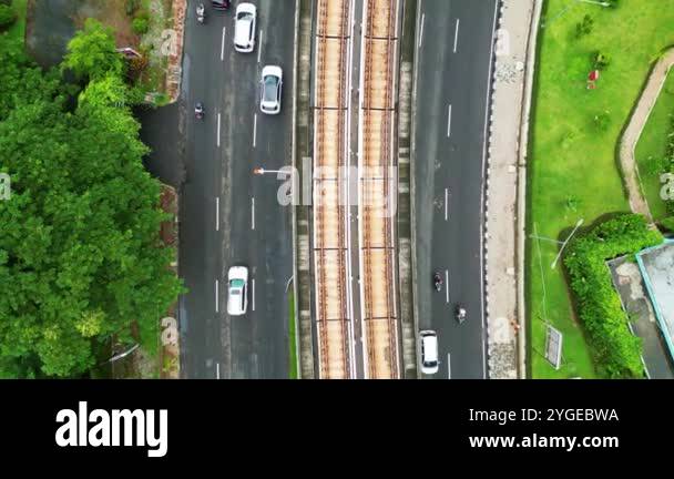 Drone footage of Jakartas MRT rail line and busy roads, showcasing the urban transport network ...