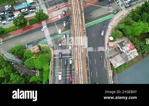 Drone footage of Jakartas MRT rail line and busy roads, showcasing the urban transport network ...