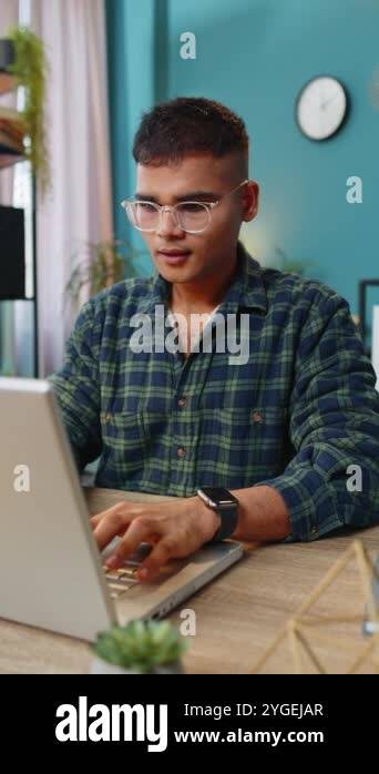 Happy Indian man closing laptop pc after finishing work. Hispanic guy ...