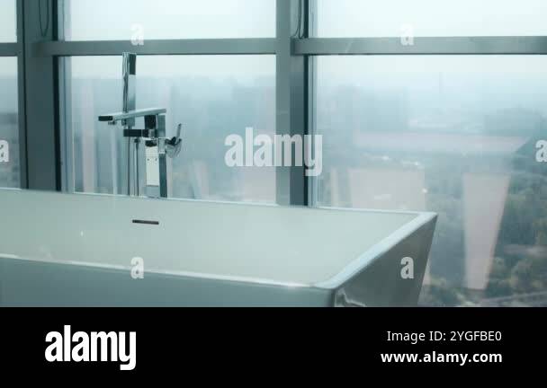 No people shot of sleek, modern freestanding bathtub with chrome faucet ...