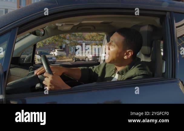 Angry irritated handsome black male driver stuck in traffic jam ...