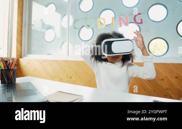 African girl taking off VR glass or head set while looking at camera. Student smiling at camera ...