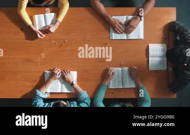Top view of prayer hold each other support while prays to god at table ...