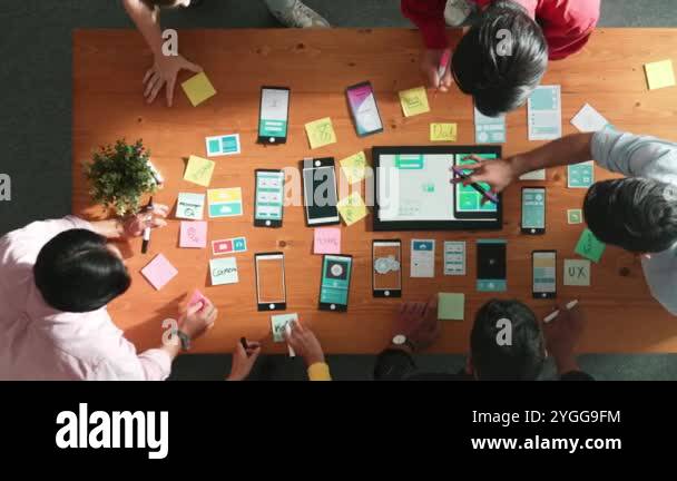 Top view of developer team working together to write idea about Ux ui design on colorful sticky ...