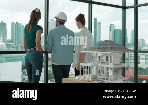 Smart architect engineer team in casual outfit talking while look at ...