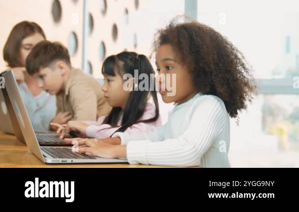 African girl play laptop with diverse friend learning prompt at STEM technology class ...