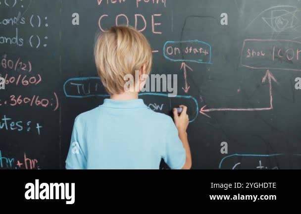 Back view of student writing engineering prompt on blackboard. Handsome ...