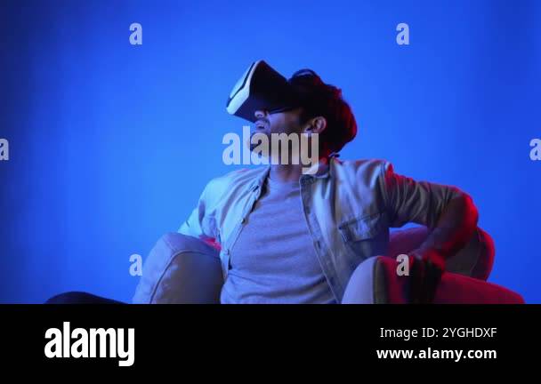 Excited caucasian man sitting at sofa with fear while watching horror ...