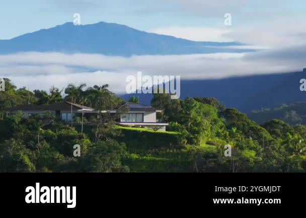 An aerial view showcases a stunning modern home nestled in lush Costa ...