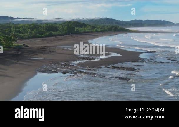 An aerial view shows a father and son joyfully walking along a ...