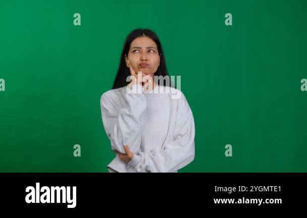 Reflective choices. Thoughtful woman in a studio portrait, exploring ...
