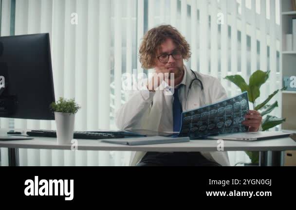 A Doctor Works, Analyzing X-rays and CT Scans on a Computer Screen He ...