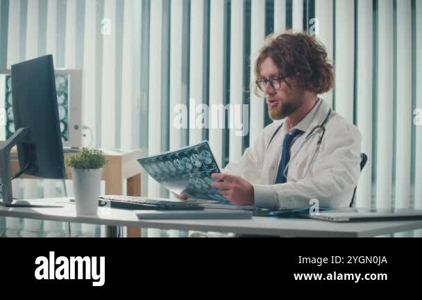 A Doctor Works in a Modern Office, Analyzing Digital Medical Data and X ...