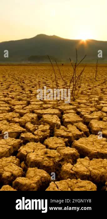 Drought and climate change, cracked earth with orange sky after lake ...