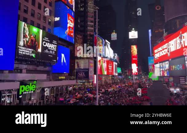 This nighttime video captures a bustling city with large crowds in ...