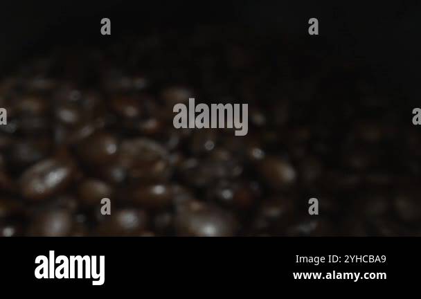 Pile of roasted coffee beans gathering and scattering at separated ...