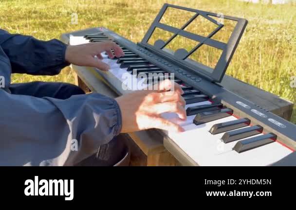 Close-up footage of a musician's hands skillfully playing an electronic ...