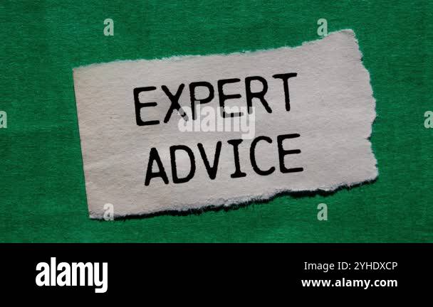 Expert advice message writing on ripped torn paper piece on green background. Conceptual expert ...