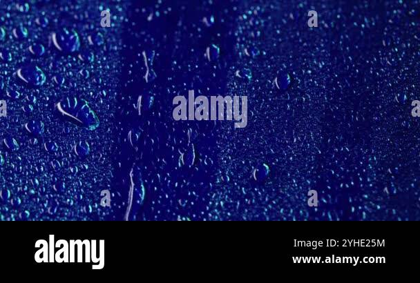 Drop surface. Blue condensation. Different sizes clean drops flow on ...