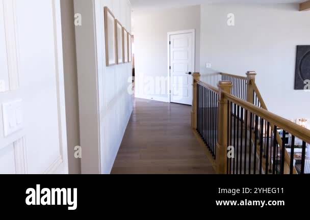 Inside an elegant home, polished hardwood floors guide the way through ...