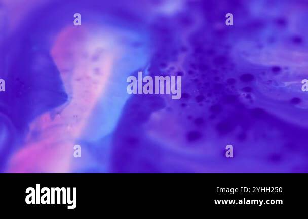 Sparkling serum. Wet foam. Defocused neon blue pink color glitter oil ...