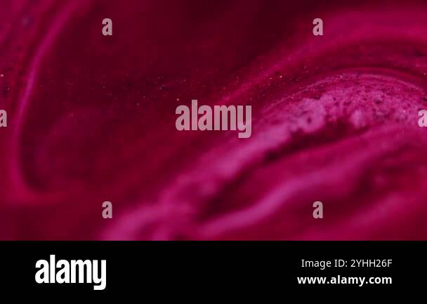Sparkling ink wave. Paint spill. Defocused red pink color shimmering ...