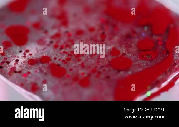 Liquid shimmer drip. Glitter paint mix. Blur red color shiny sequin ...