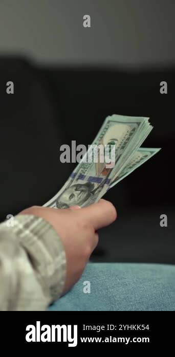 Close-up of hands counting stack of hundred dollar bills. Strategic financial management ...