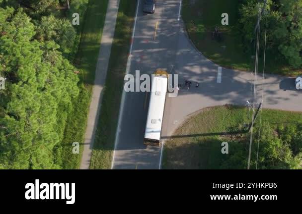 Students boarding school bus at bus stop before going to lessons ...
