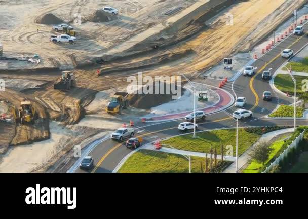 Industrial roadworks. Roundabout on wide American highway under construction. Development of ...