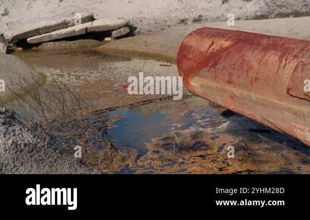 Water flows from a big metal pipe. Drainage system of sand quarry Stock ...
