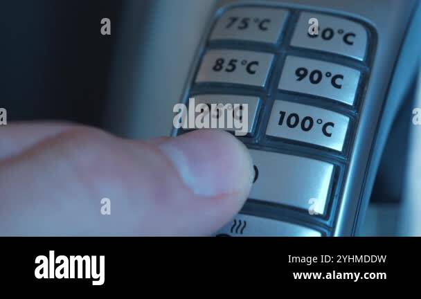 Turning on an electric kettle with adjustable water heating temperature ...