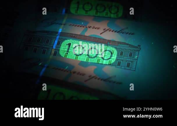 Security signs and elements under UV light on banknote 1000 Hryvnia of ...