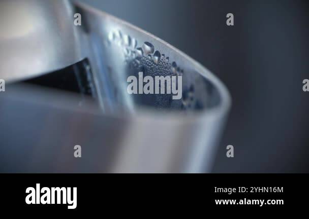 Boiling water in a kettle. Steam comes out of the kettle spout. Water ...