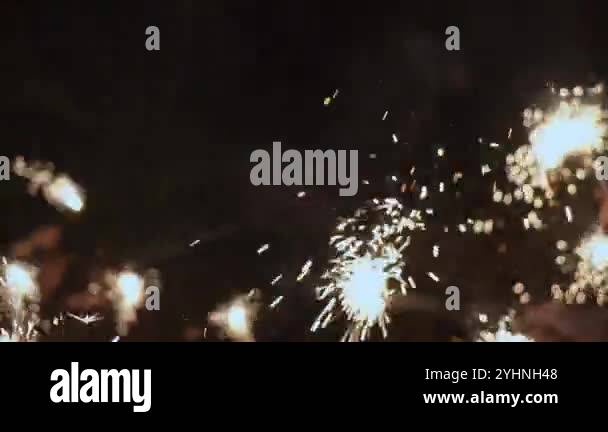 A lively scene with multiple sparklers illuminating the night. Perfect ...