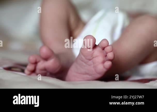 Feet of newborn baby. Funny little feet of neonatal three weeks old ...