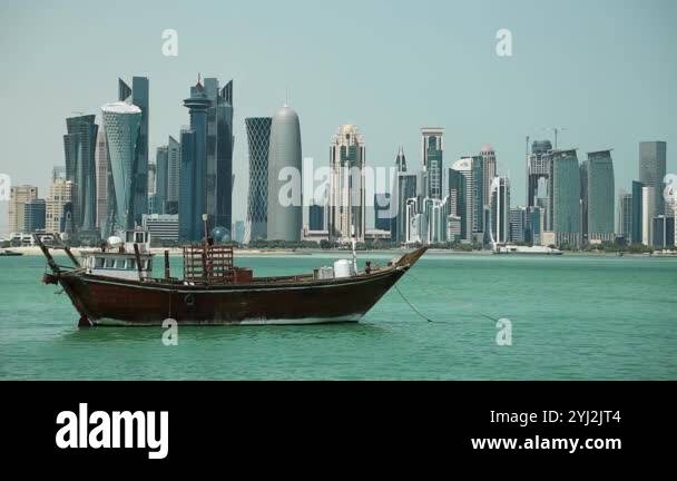 Financial district and dhow - traditional wooden Qatari boat, Doha Bay ...