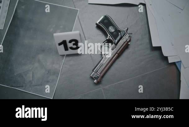 Bank robbery or murder case. Top view on murder weapon gun lying next ...